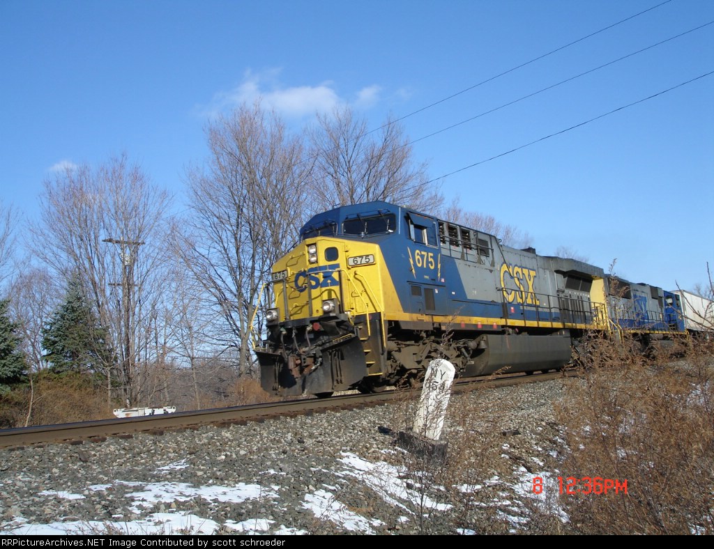 CSX 675 & CSX 710 head WB past a private road crossing
